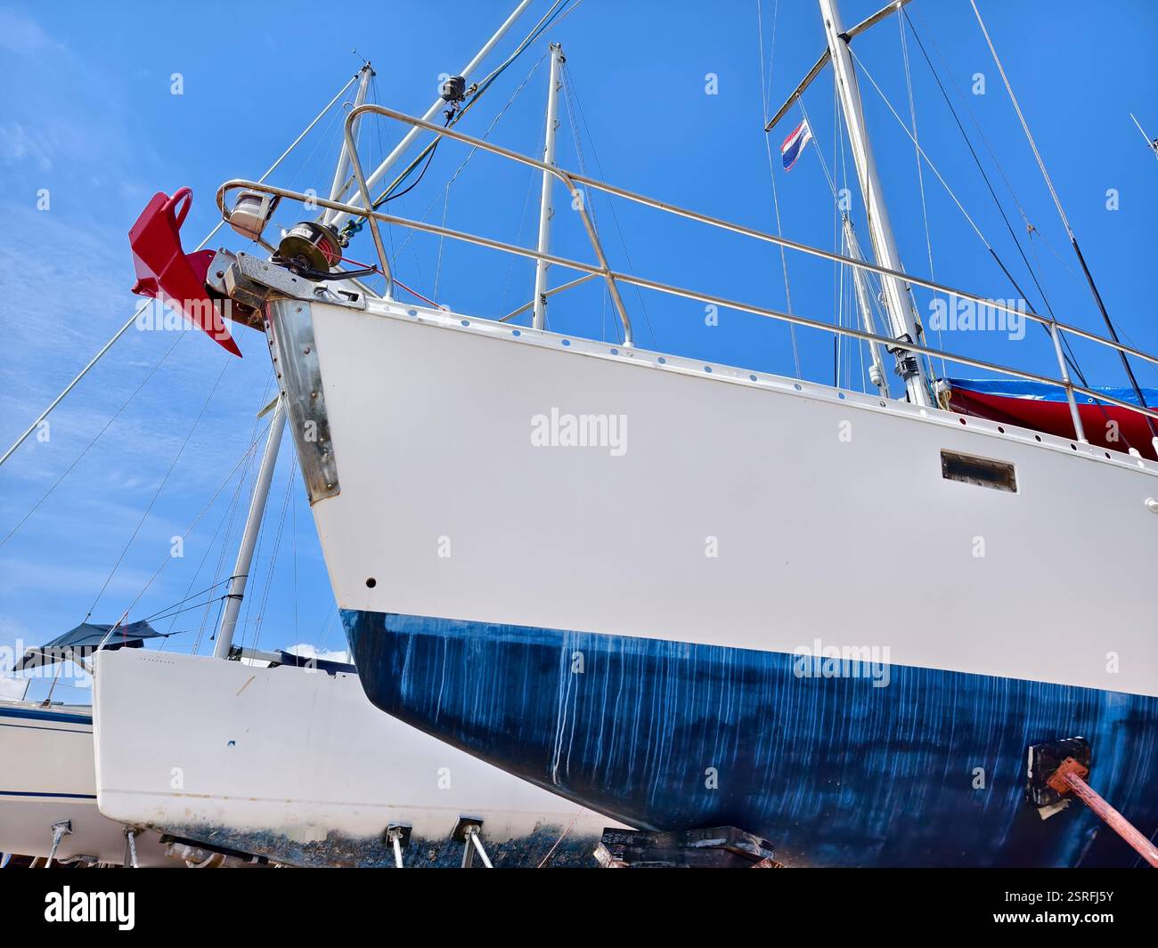 A white voyage boat featuring a steering wheel floating in the dock ...