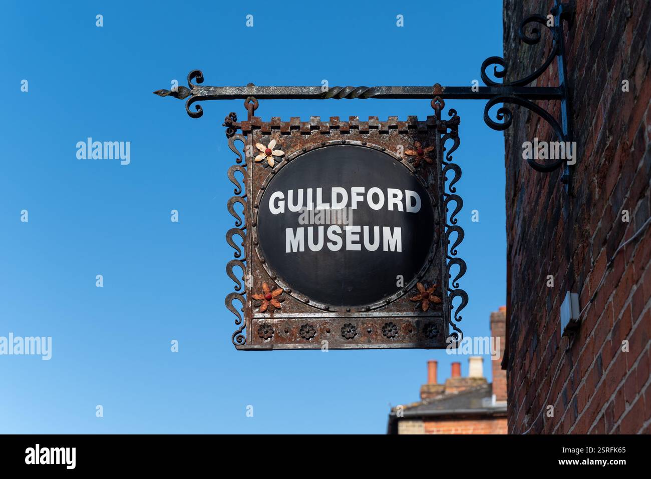 Metal hanging sign at the entrance to Guildford museum. February 2025 ...