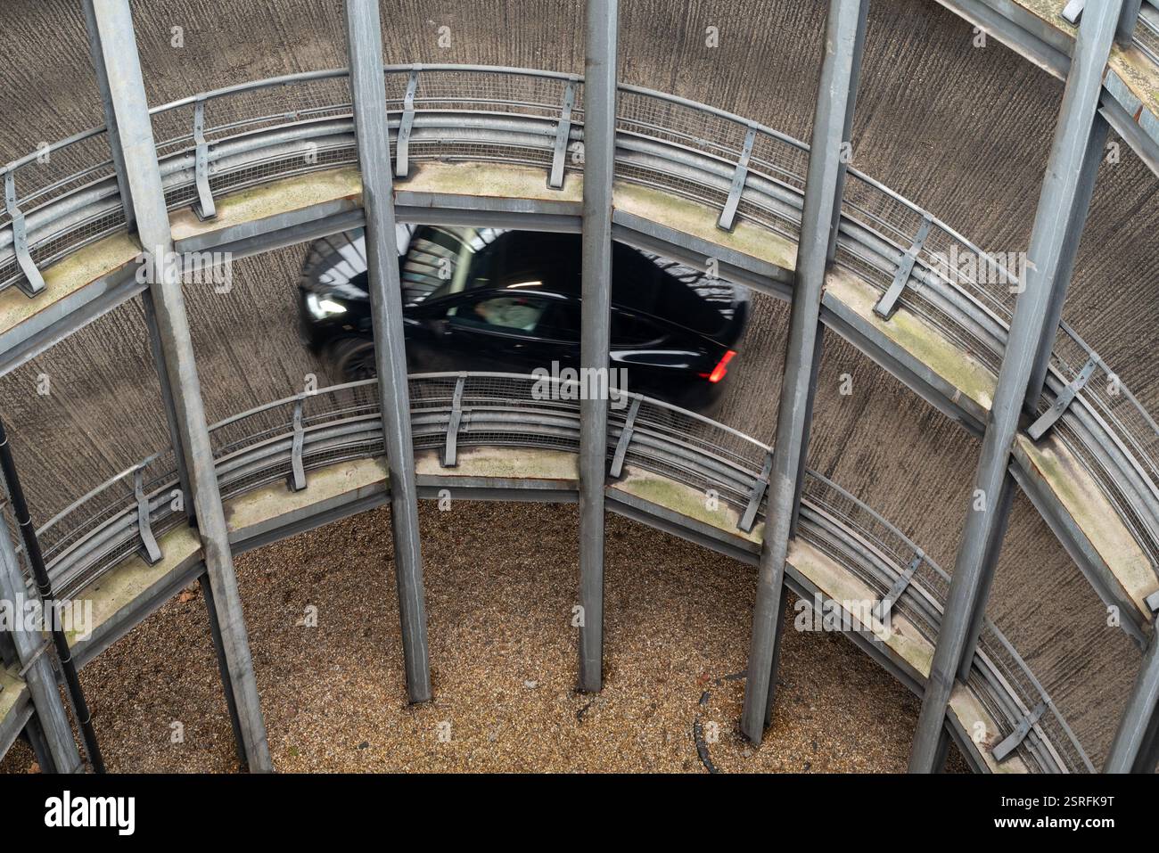 Looking down at part of the circular ramps of a multi storey car park ...