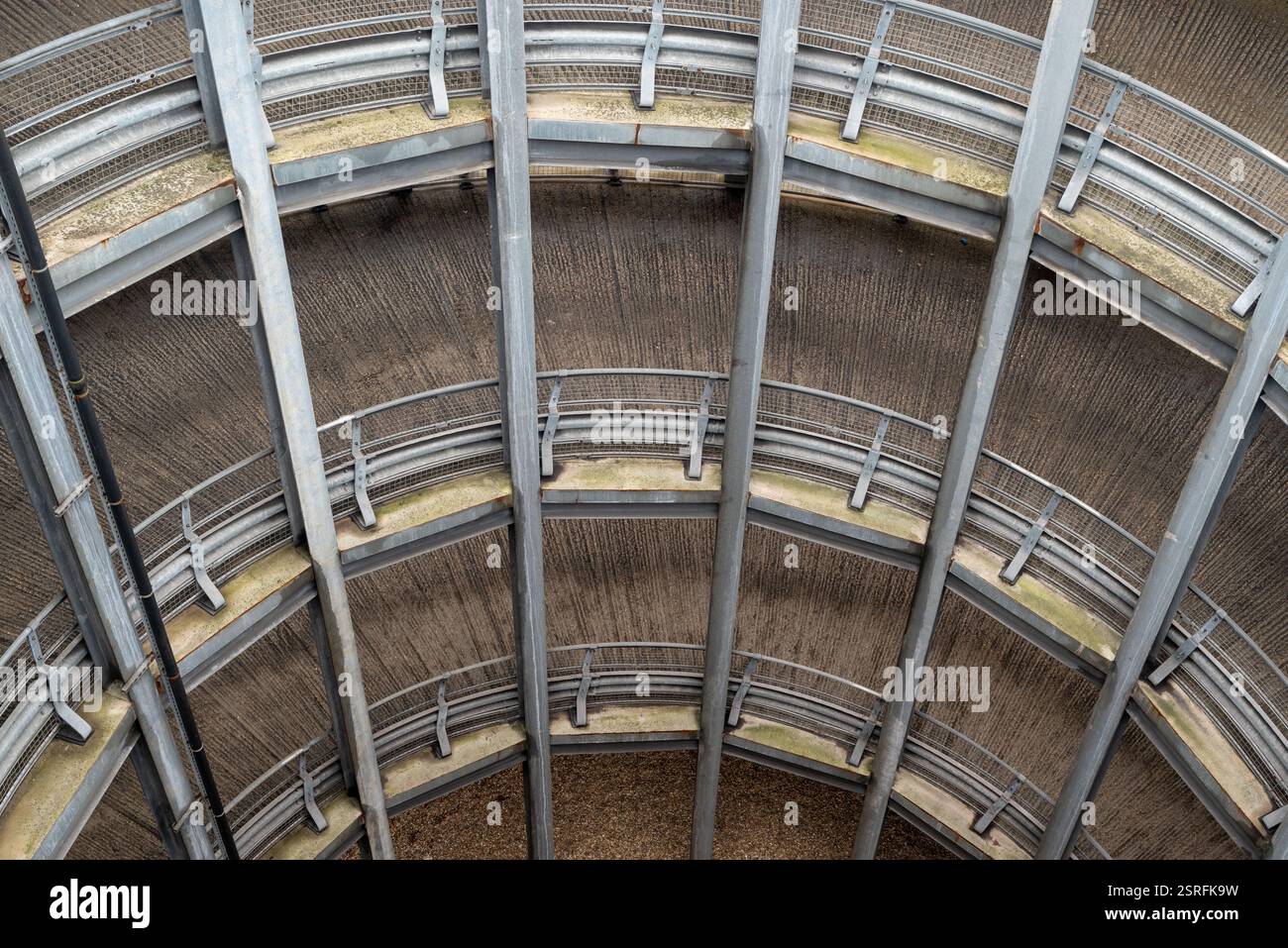 Looking down at part of the circular ramps of a multi storey car park ...