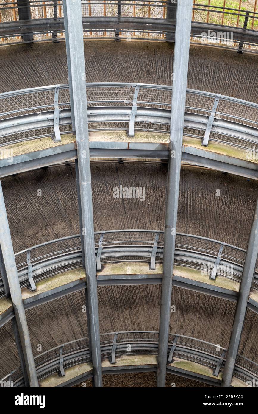 Looking down at part of the circular ramps of a multi storey car park ...