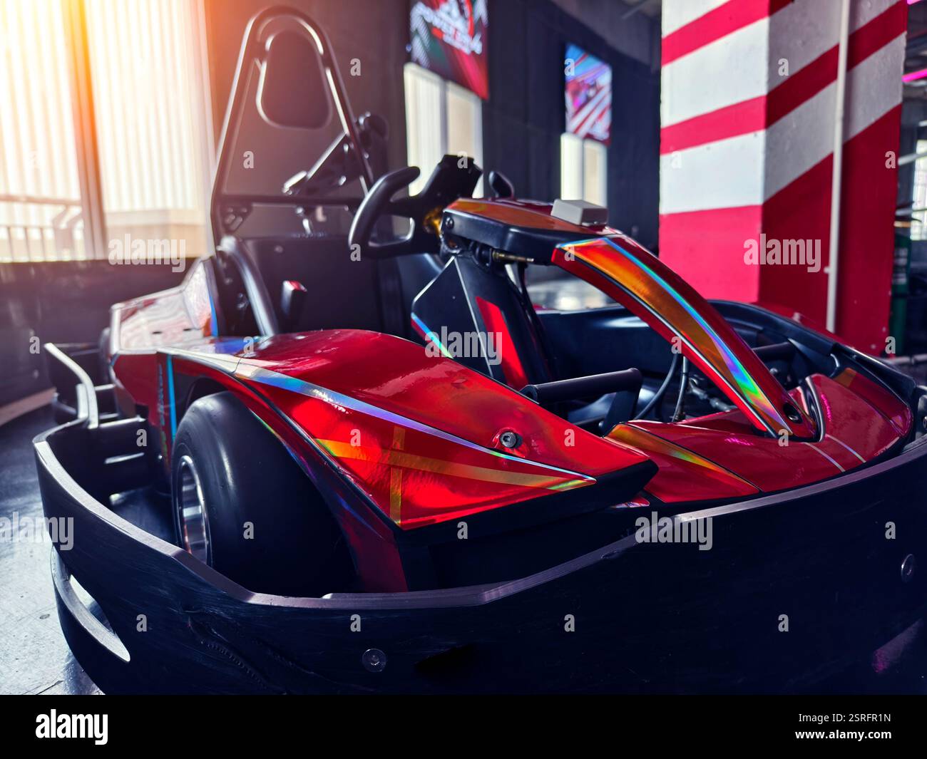 New electric go karts in the modern indoor racing track Stock Photo - Alamy