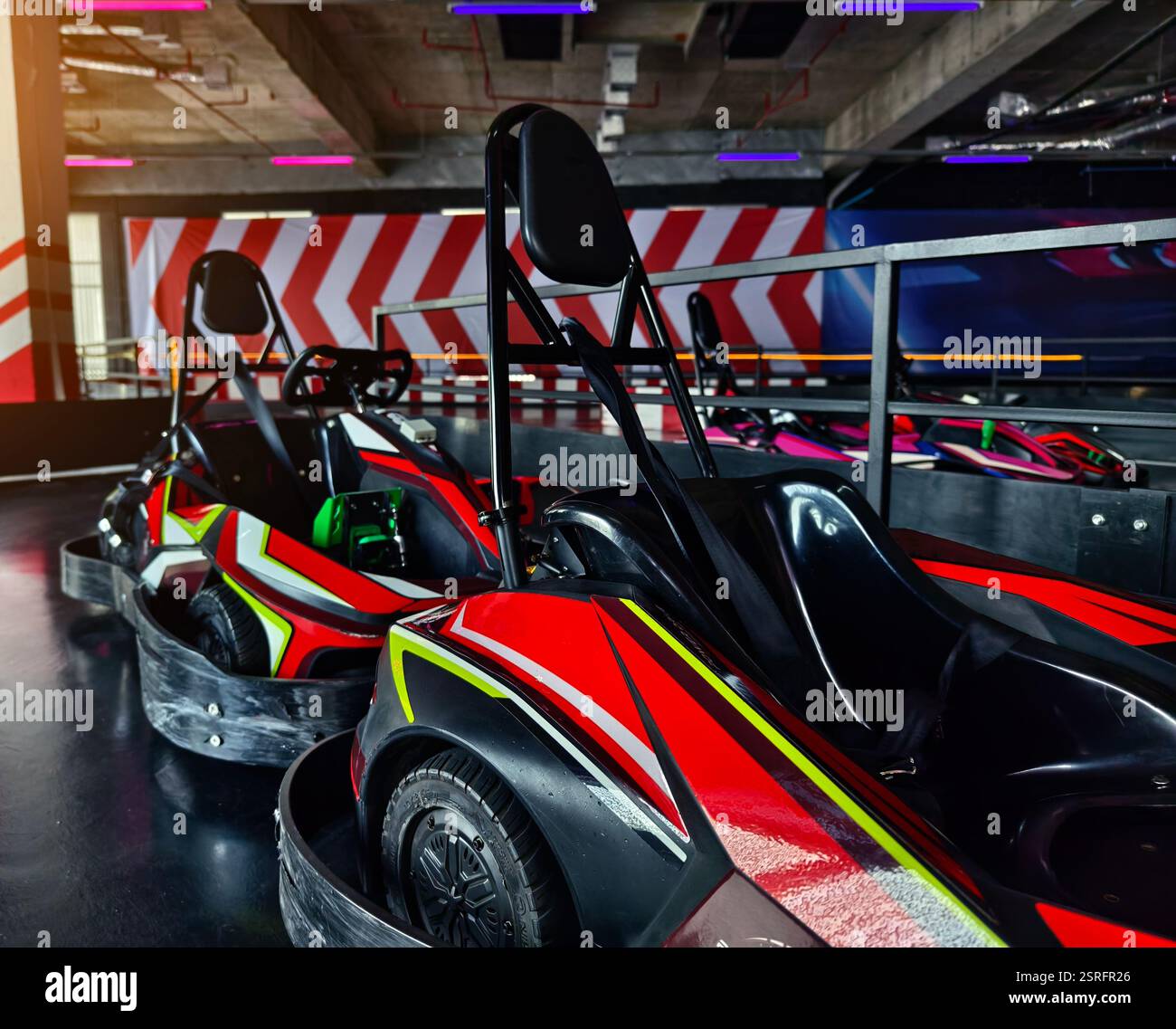 New electric go karts in the modern indoor racing track Stock Photo - Alamy