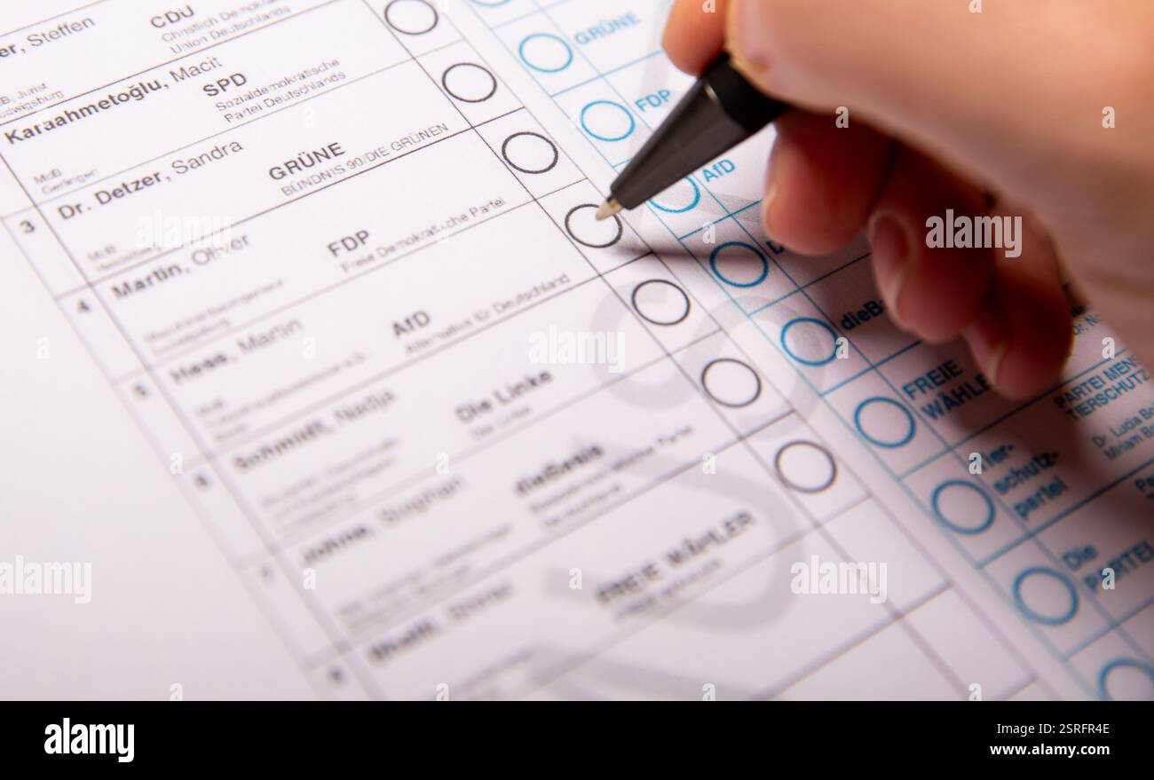 12. February 2025 - Berlin, Germany. Close up of a female hand marking ...