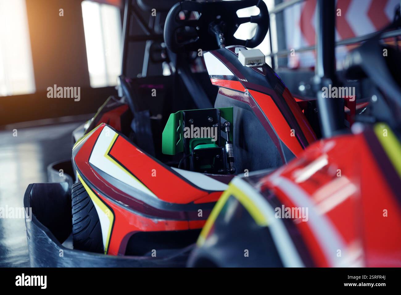 New electric go karts in the modern indoor racing track Stock Photo - Alamy