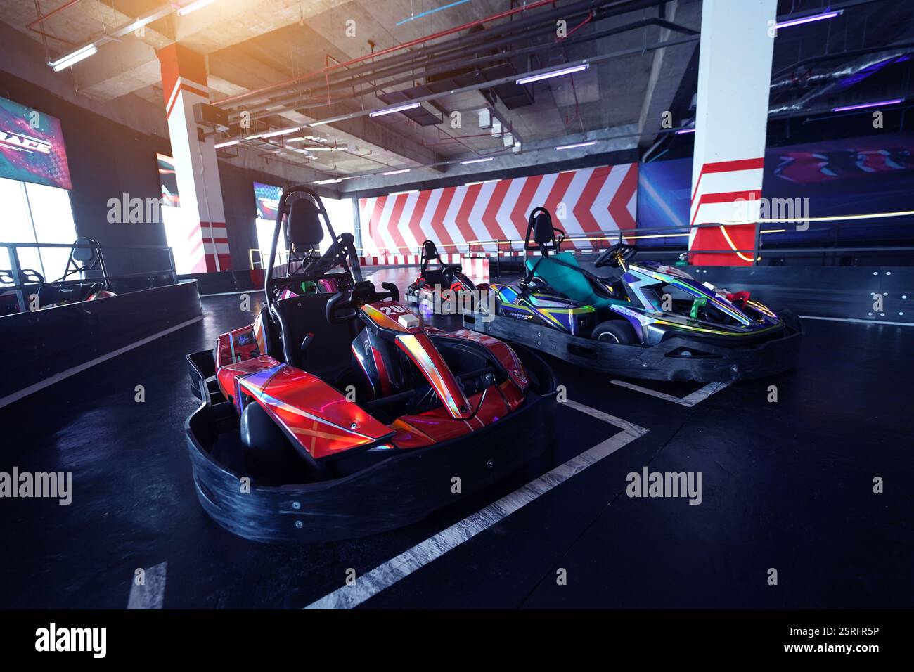 New electric go karts in the modern indoor racing track Stock Photo - Alamy