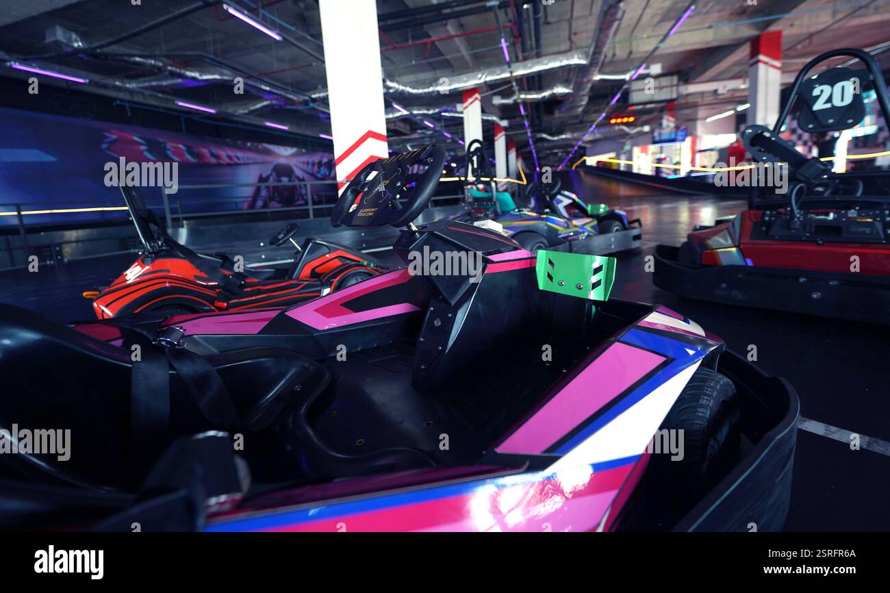 New electric go karts in the modern indoor racing track Stock Photo - Alamy