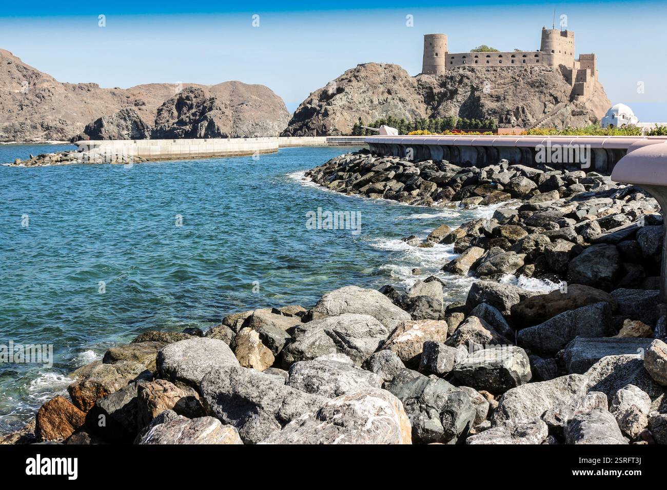 Sea, brakewater rocks and Al Jalali Fort in Muscat, Oman, seen from the ...
