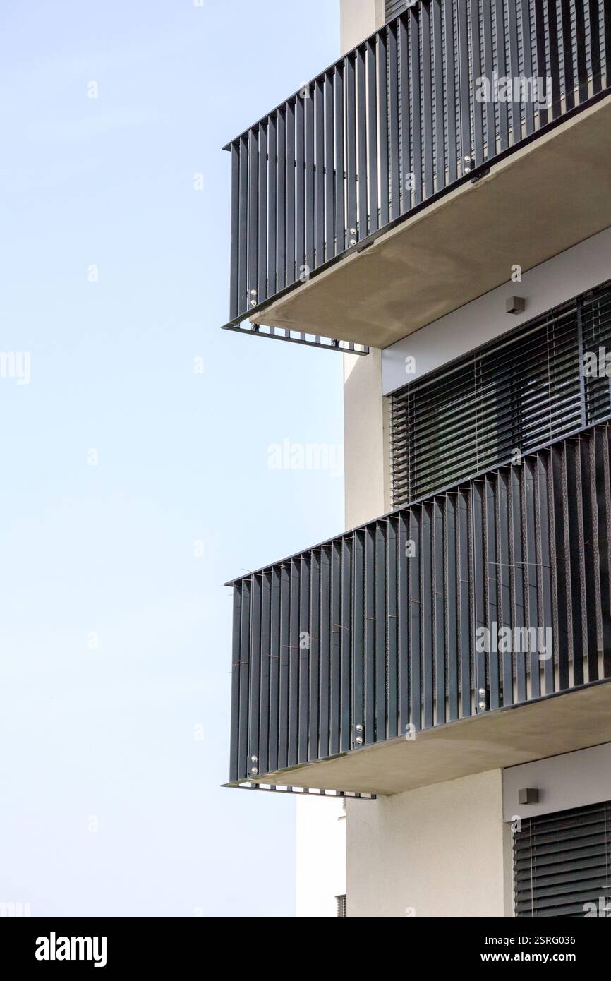 a fragment of a multi-storey building with two balconies standing out ...