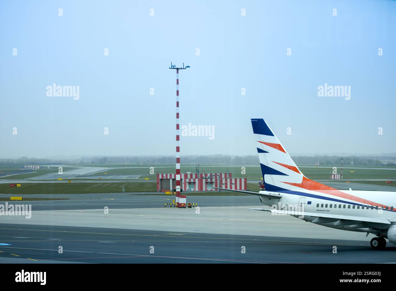 Riga,Latvia - 03.31.2024: airport apron with airplane and control tower ...