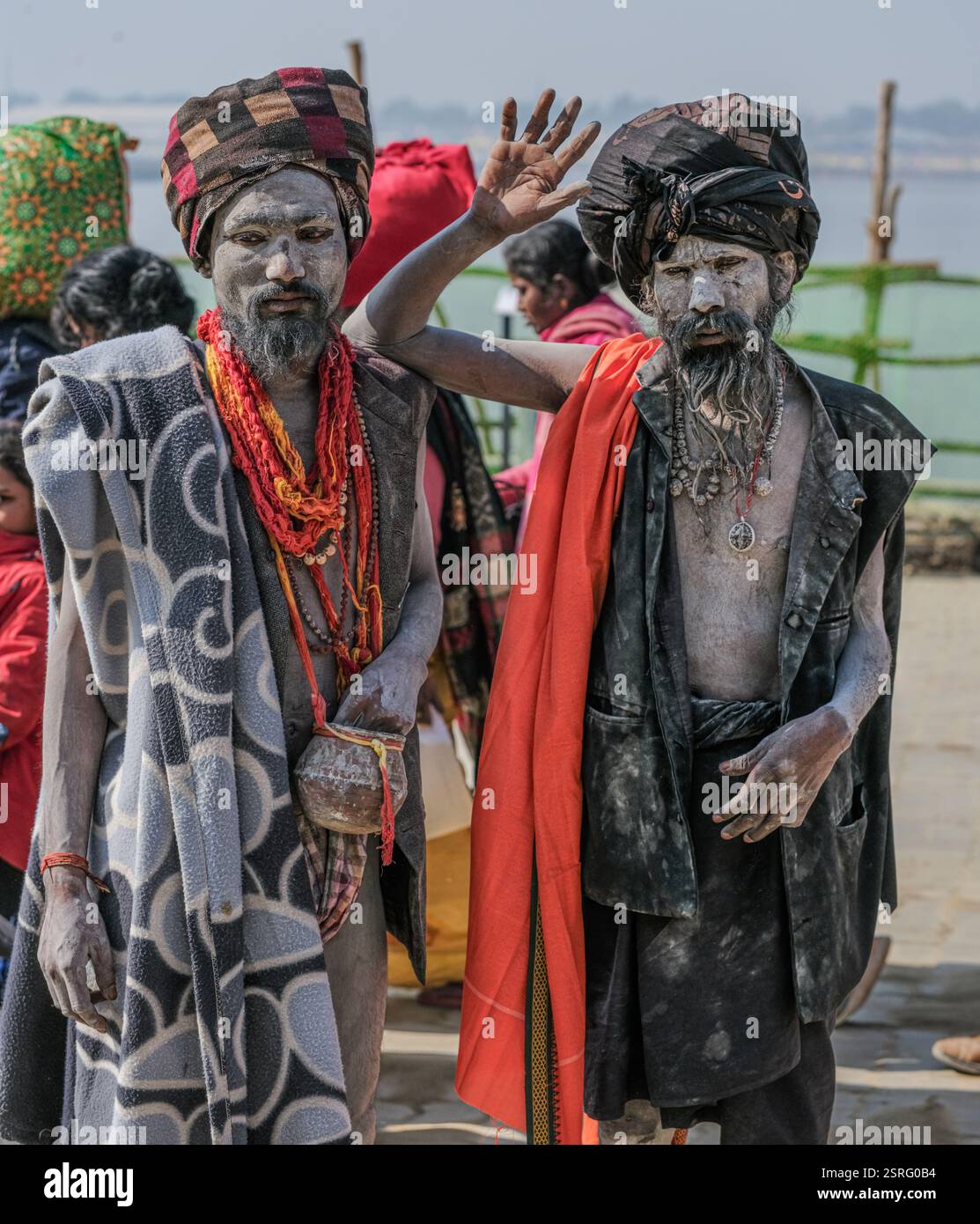 Traditional Hindu ascetics covered in ashes stand together during the ...