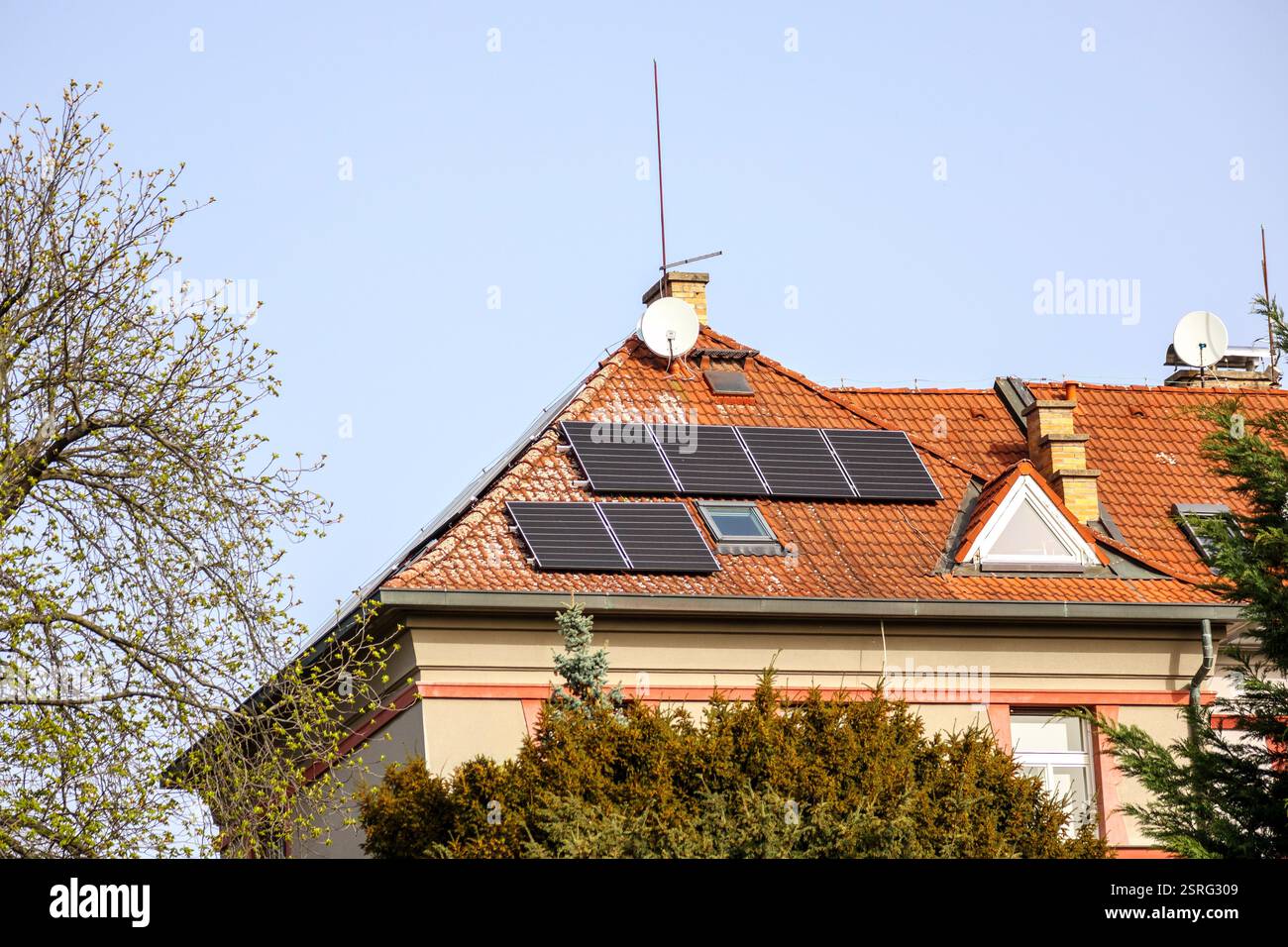 a two-story building with solar panels on the roof Stock Photo - Alamy