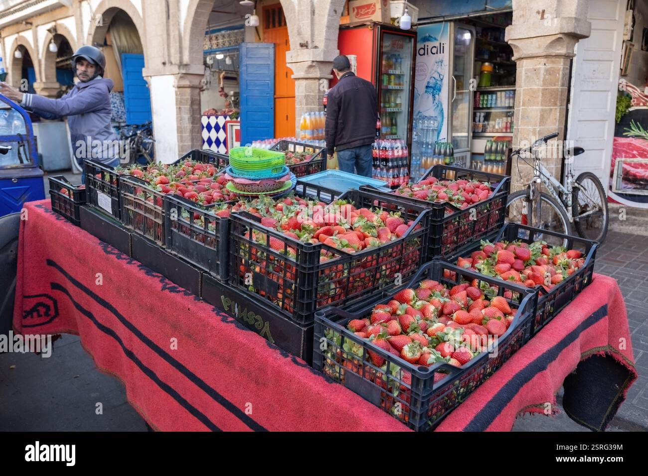 Arab man selling Fresh strawberries on the market in Essaouira medina ...