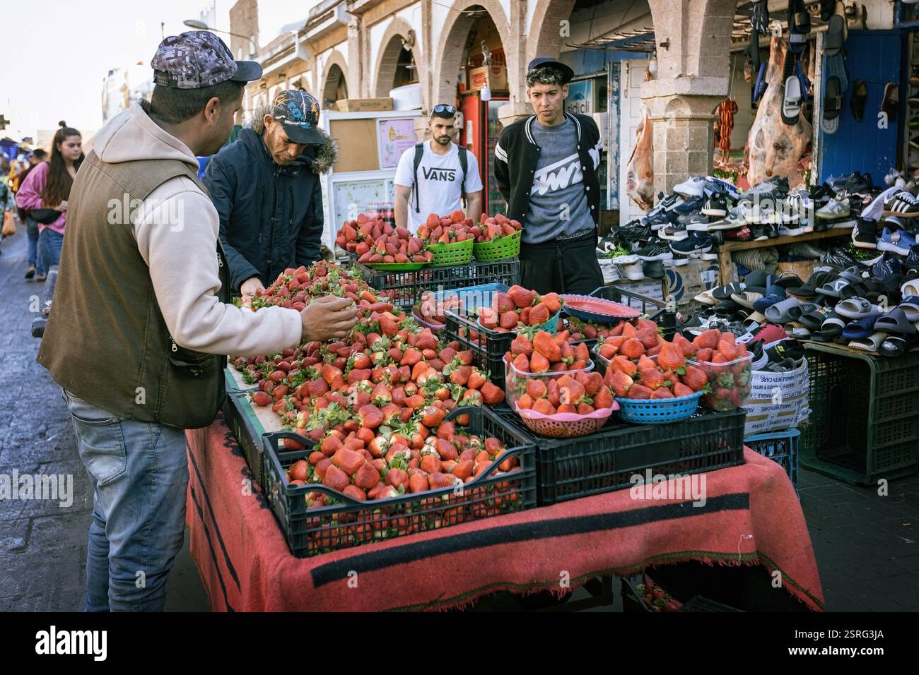 Arab man selling Fresh strawberries on the market in Essaouira medina ...