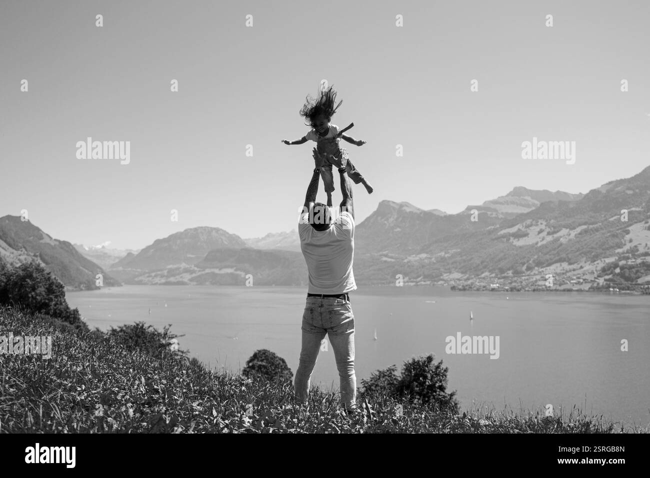 Happy dad playing with child on nature. Father lifting, throwing child ...