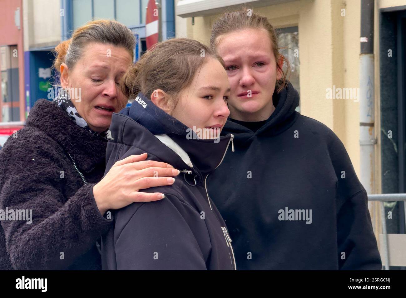 People mourn at the site of stabbing a day after an attack that left a ...
