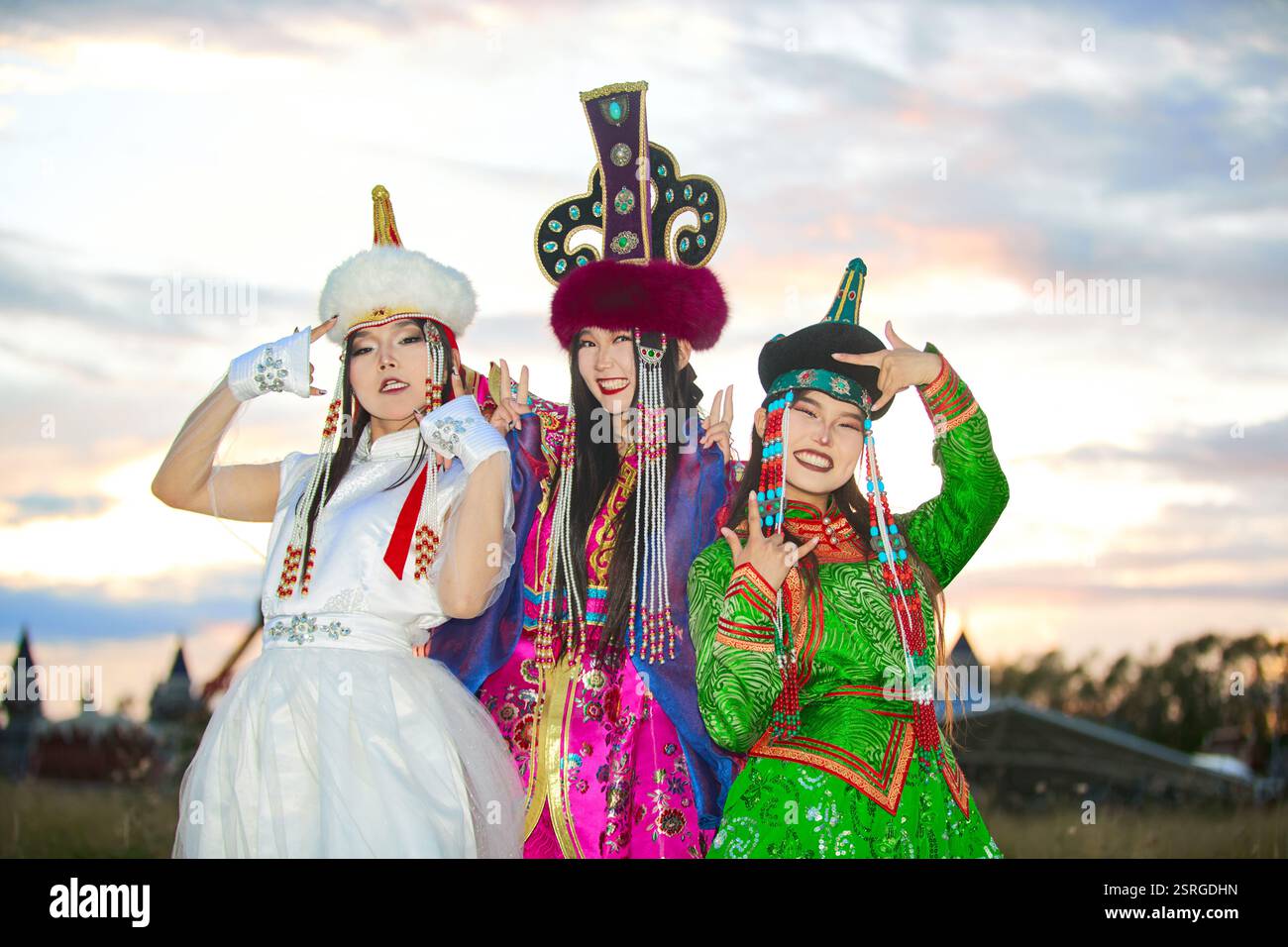Three Mongolian girls wearing traditional Mongolian tribal costumes ...