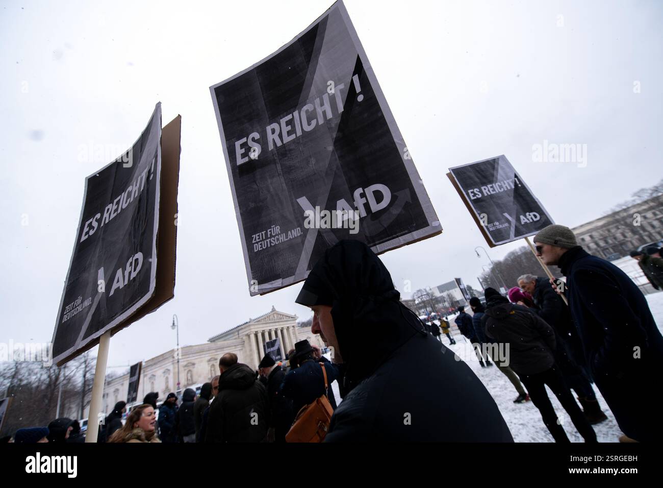 16 February 2025, Bavaria, Munich: Participants at an AfD vigil hold up ...