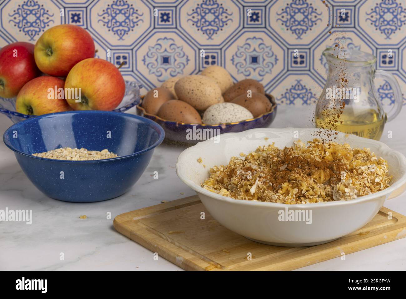 Sprinkle a pinch of cinnamon on a mixture of apple and oatmeal in a ...