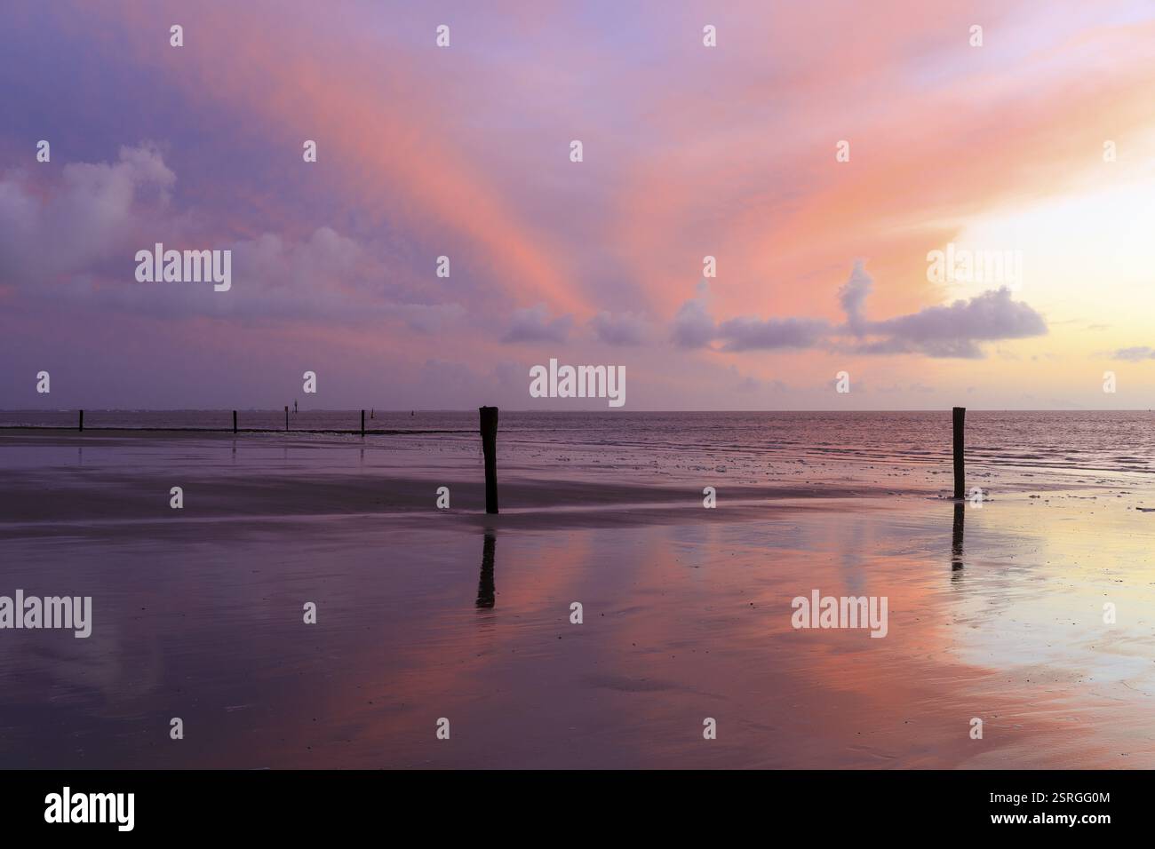 Red evening sky with reflection on the wet beach, west beach of ...