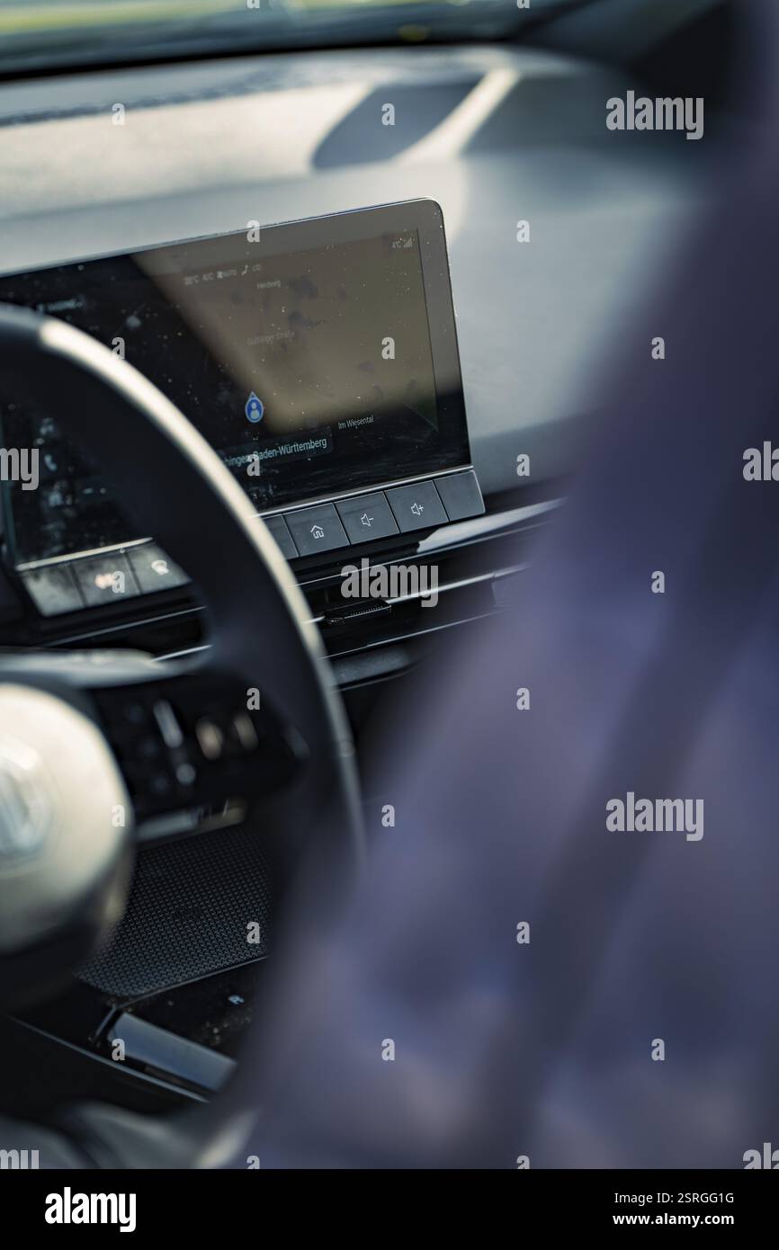 Detailed view of a modern car interior with steering wheel and display ...