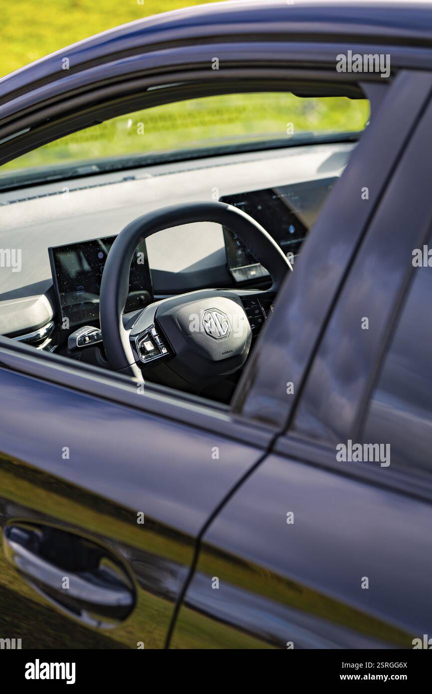 Modern car interior with steering wheel and digital screens, e-car ...