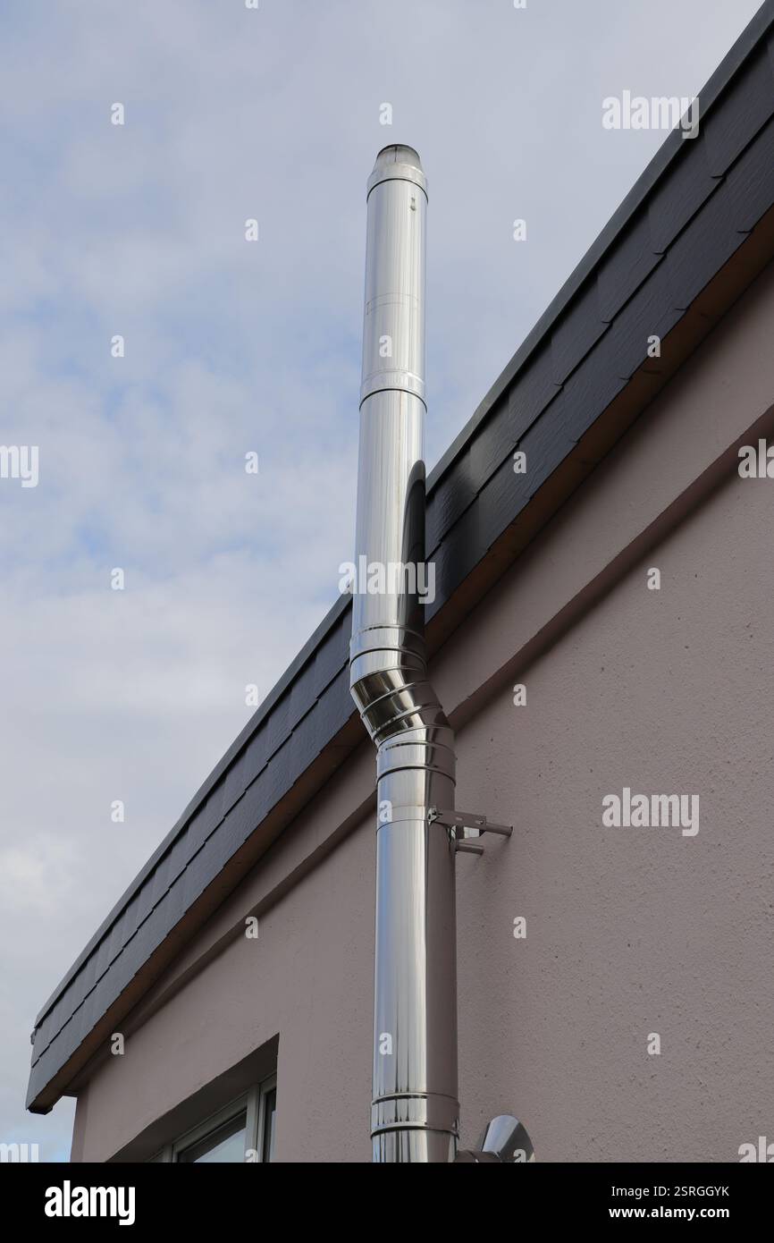 new stainless steel chimney on a house Stock Photo - Alamy