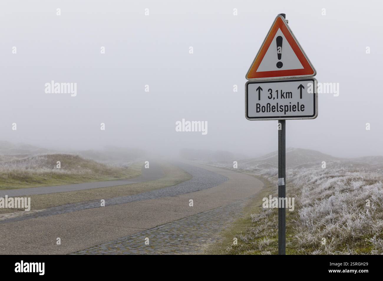 Road in the fog with traffic sign, attention, dune landscape on ...