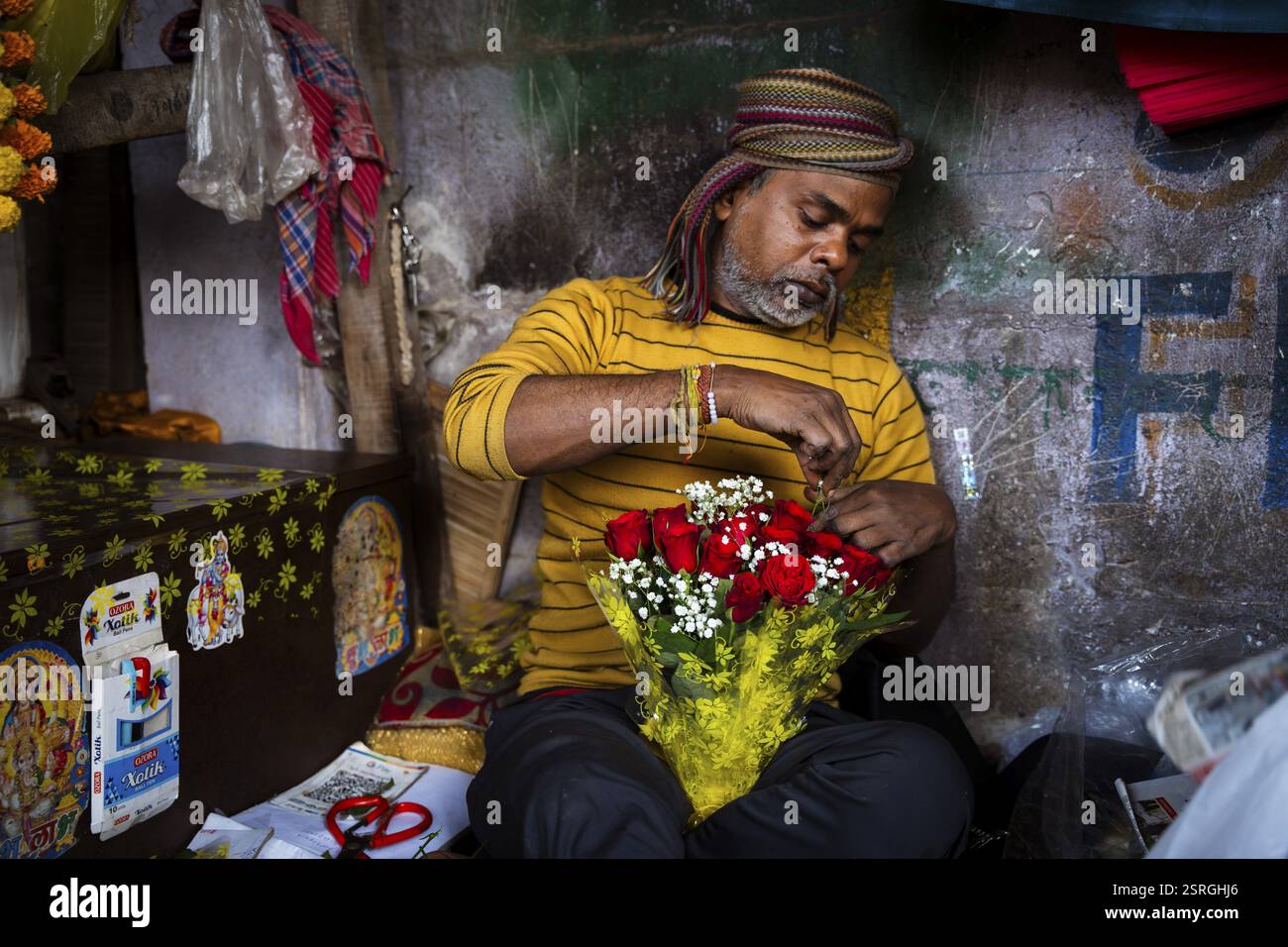 Vendor makes rose bouquet to sell in a street flower shop, on the ...