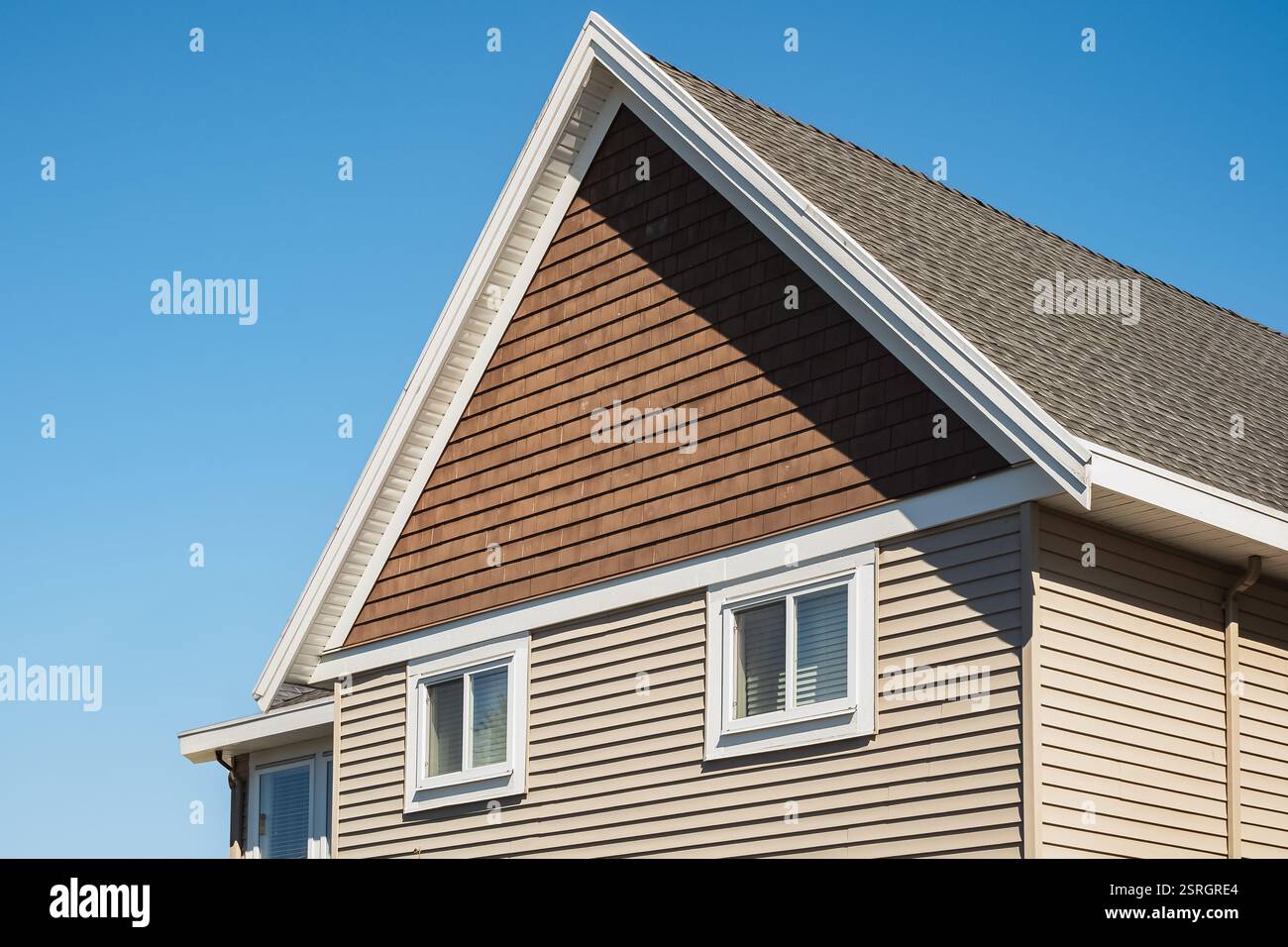 Facade of a house with nice windows in the blue sky background ...