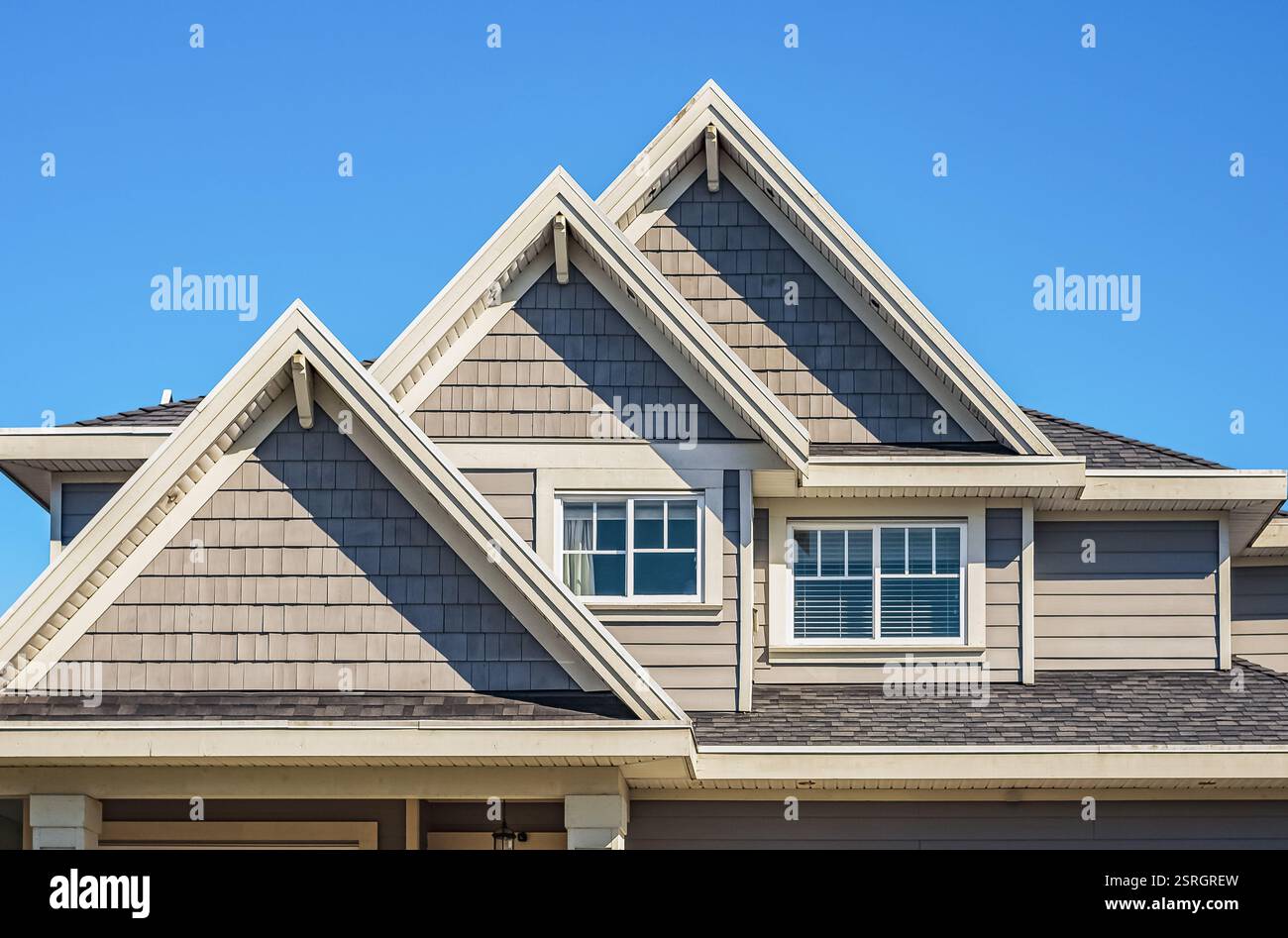 Facade of a house with nice windows in the blue sky background ...