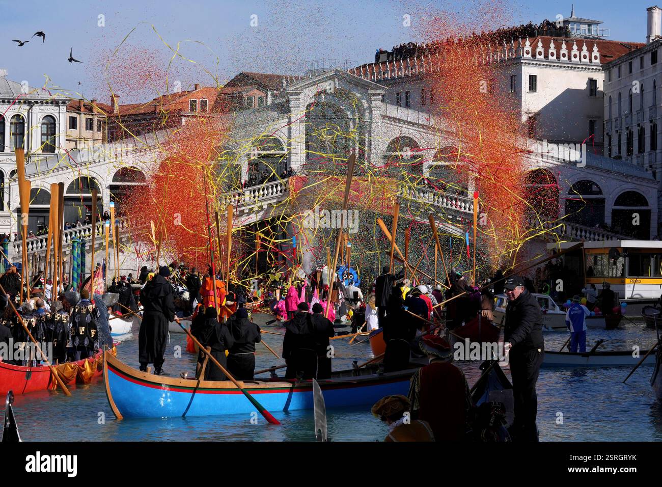 Boats sail as confetti explodes in the air under the Rialto bridge ...