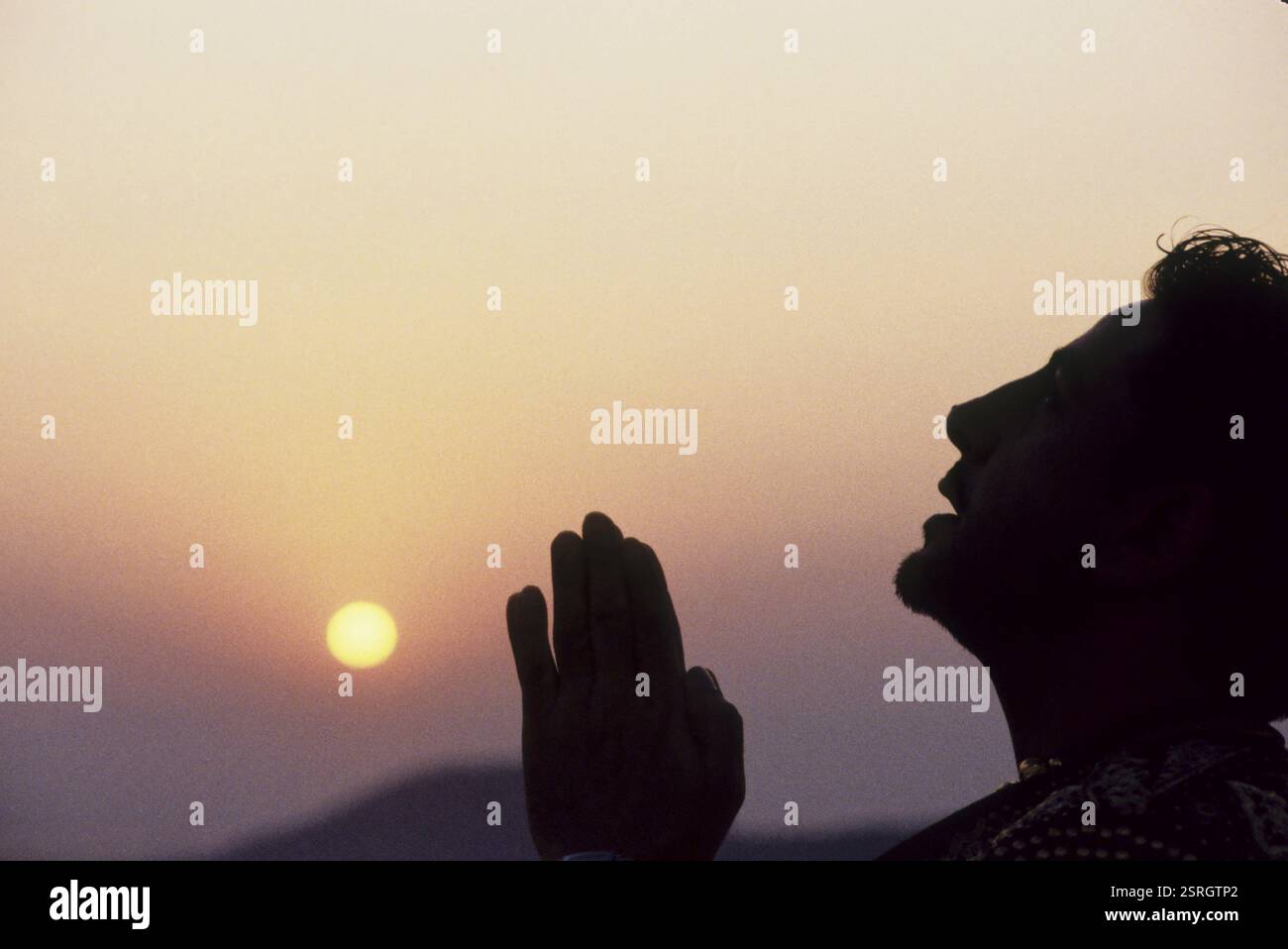 Hindu man praying sun at sunrise, india Stock Photo - Alamy