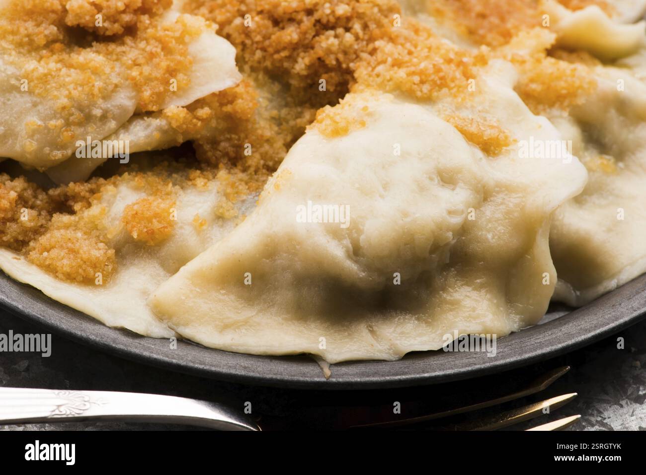Boiled pierogi (Polish dumplings) stuffed with cabbage and mushrooms ...