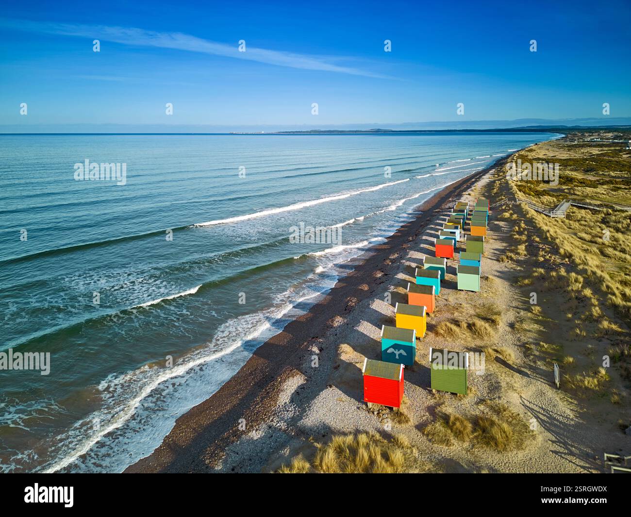Findhorn Moray Coast Scotland high tide and a row of coloured beach ...