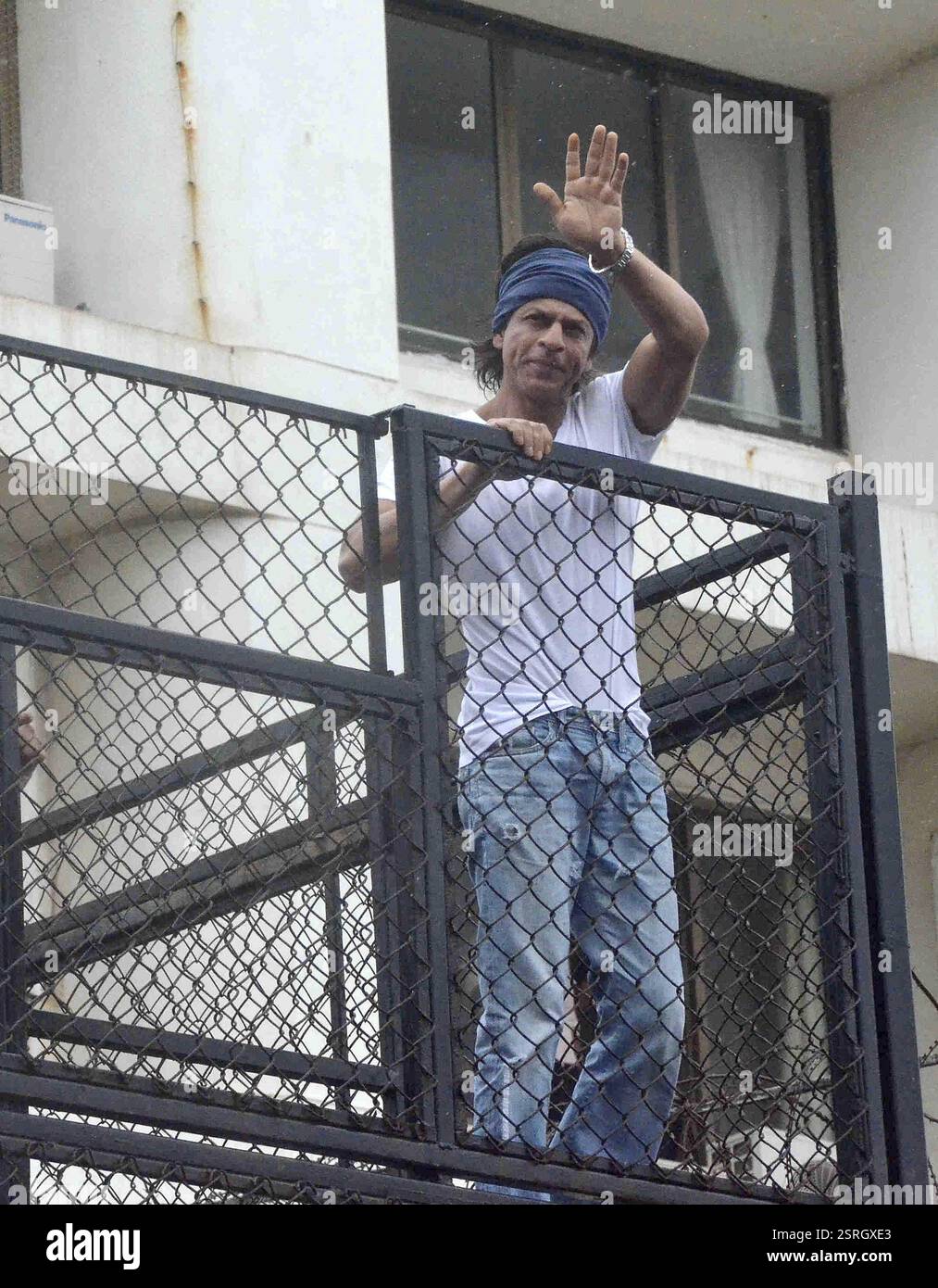 Bollywood actor Shah Rukh Khan waves crowd who had come to greet him on ...