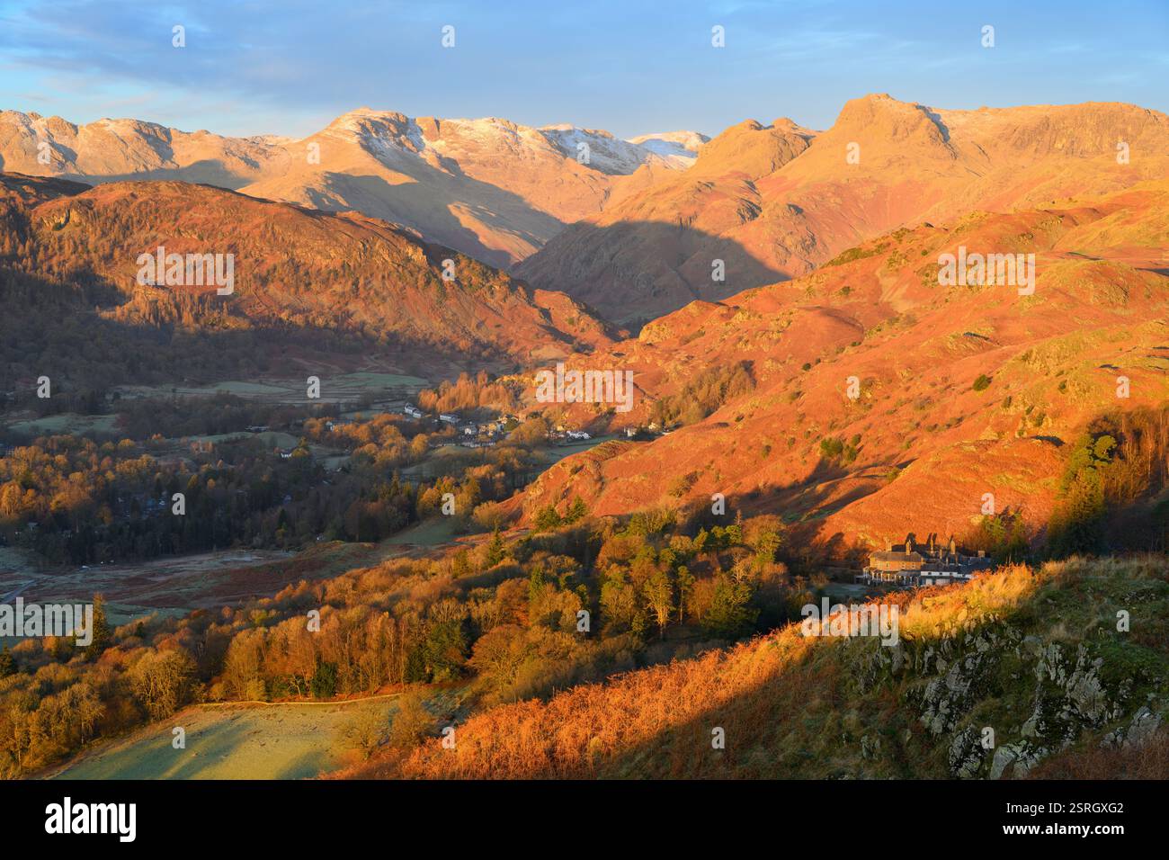Aerial view of The Langdale Pikes mountain range with beautiful golden ...