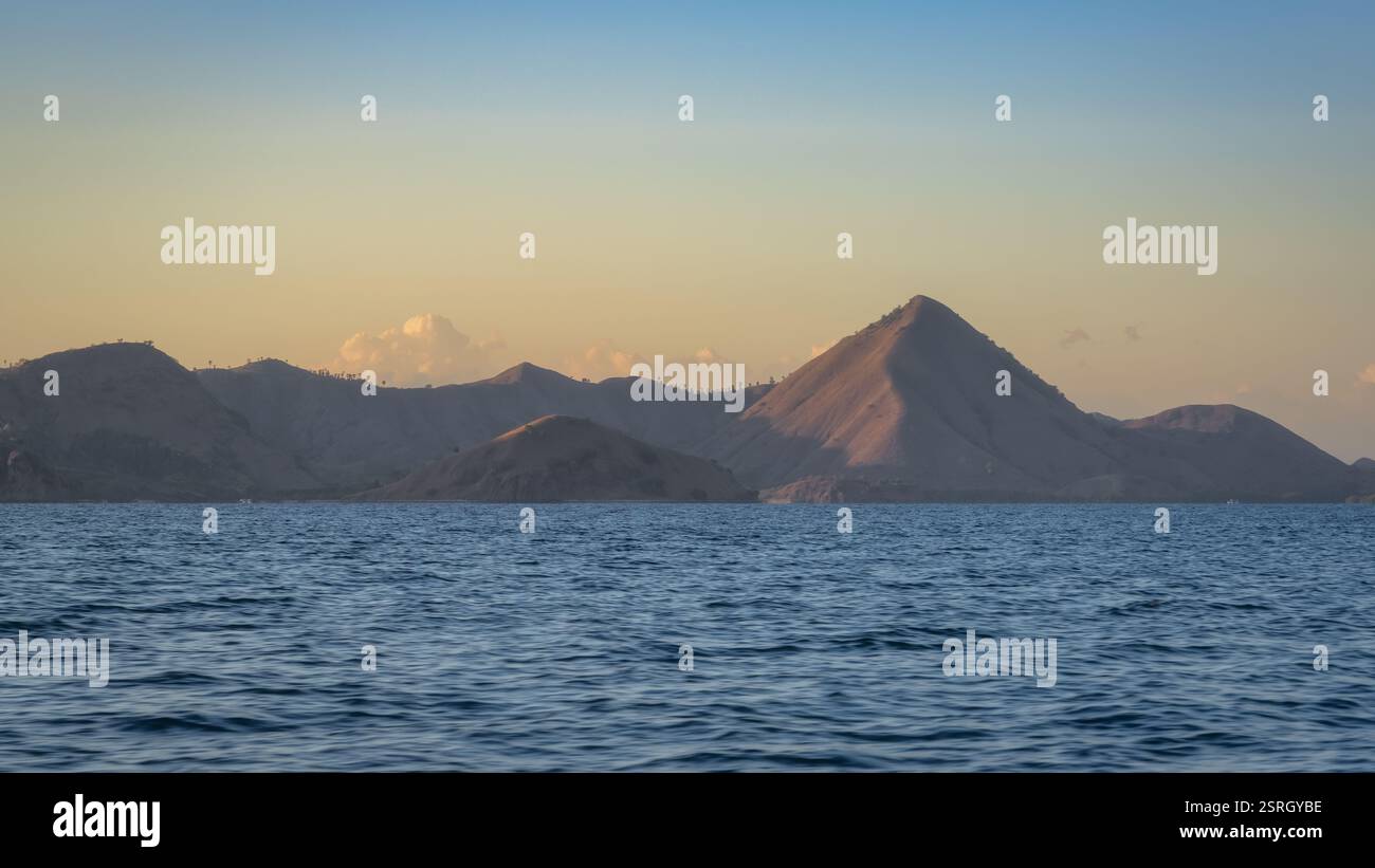 Majestic mountains beautifully reflect in the tranquil twilight waters ...