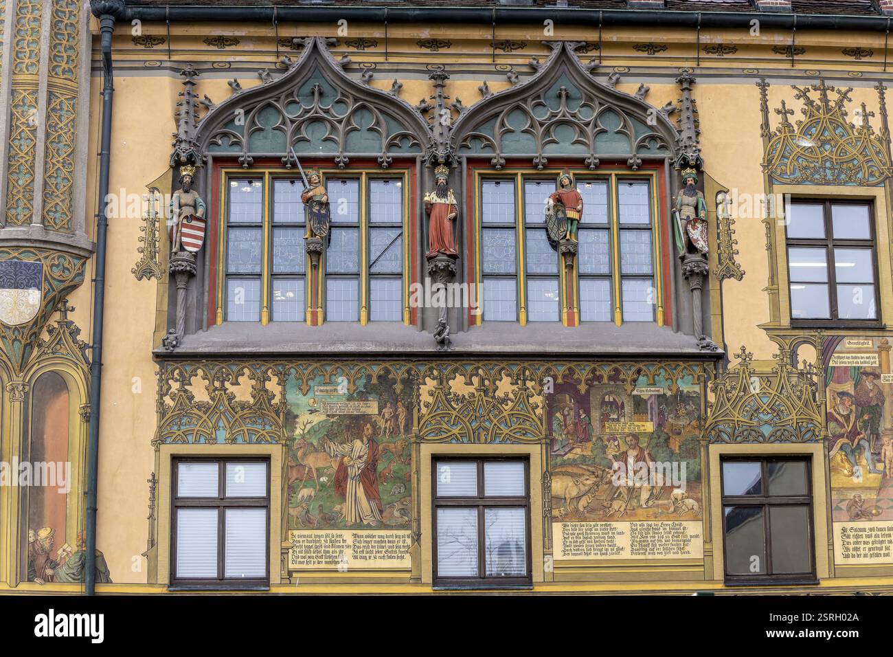 Painted facade and windows with 5 medieval human sculptures on Ulm Town ...