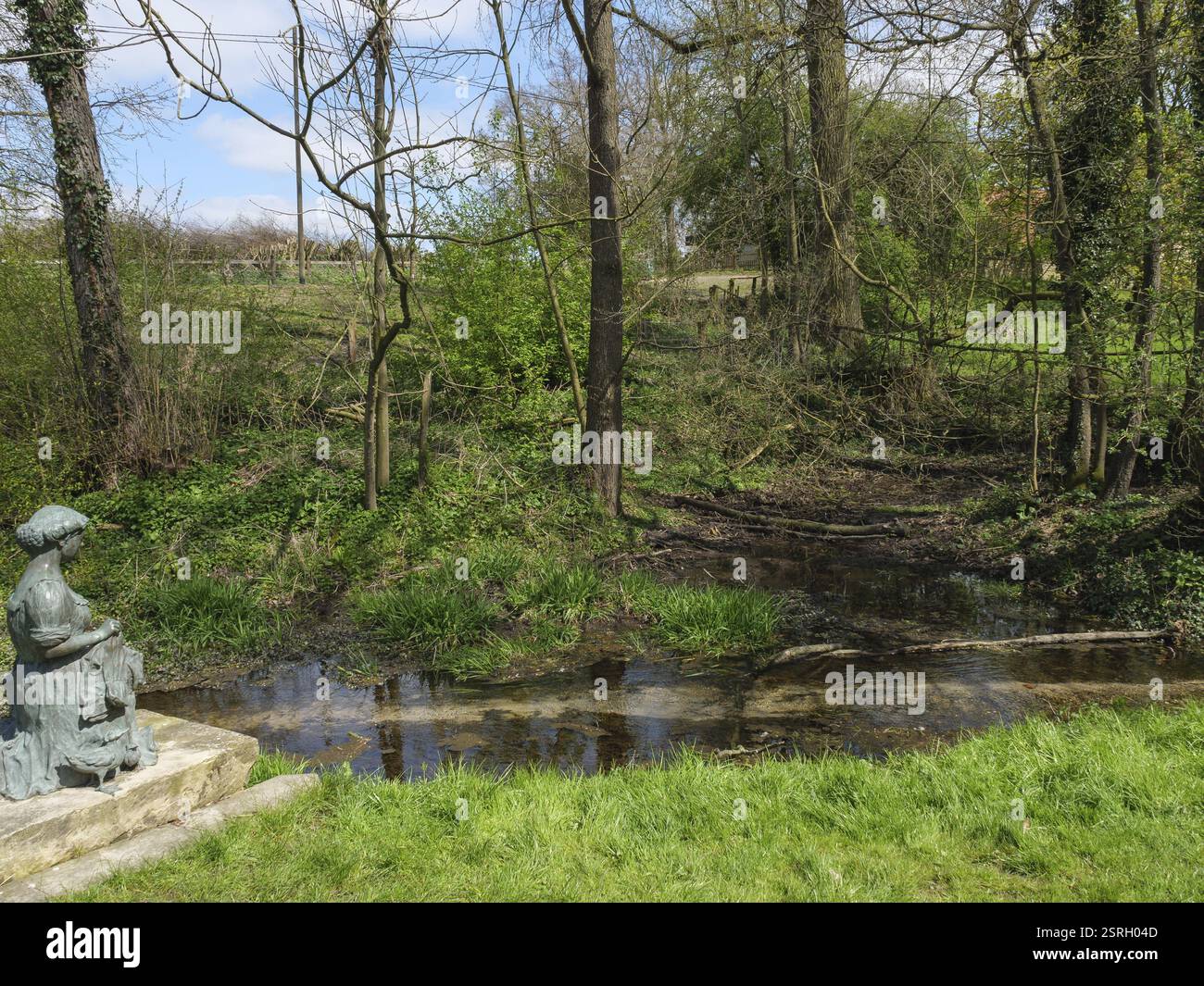 Lilac tank statue by a stream in a green forest, Darfeld, Muensterland ...