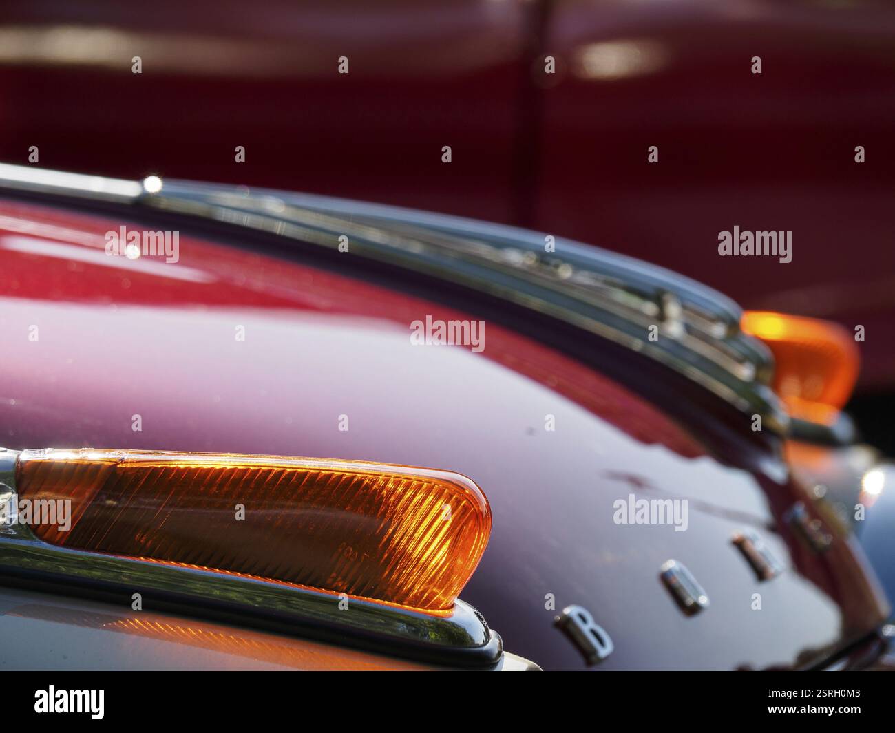 Detail of a vintage car with red paintwork and chrome accents, Bocholt ...