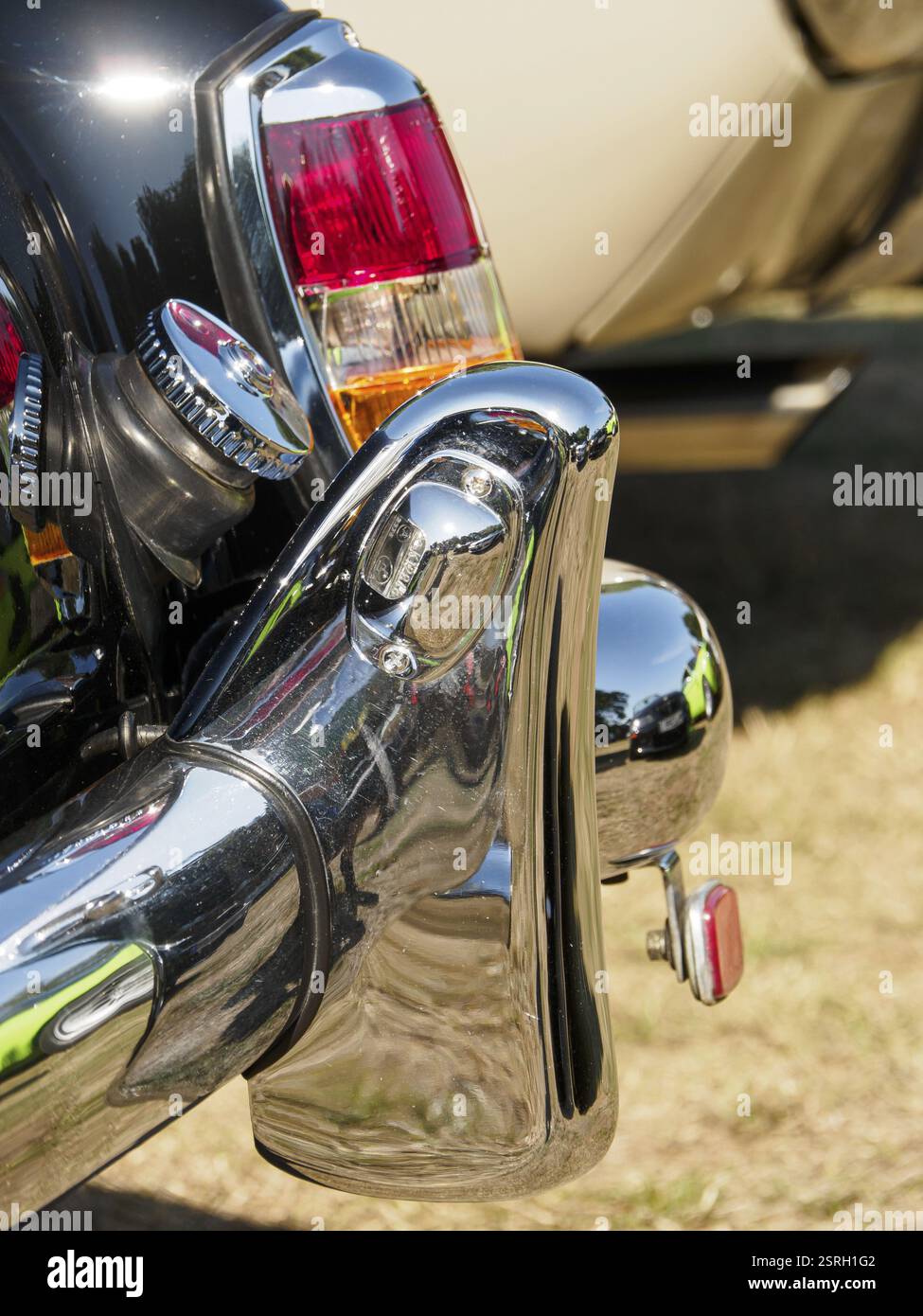 Classic car front with chrome bumper and side panel in the sunshine ...