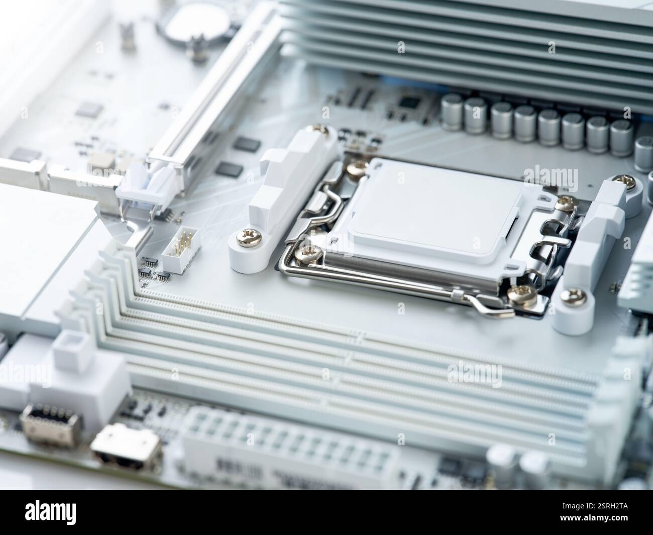 White computer motherboard without CPU cooler. Selective focus. Computer circuit board ...