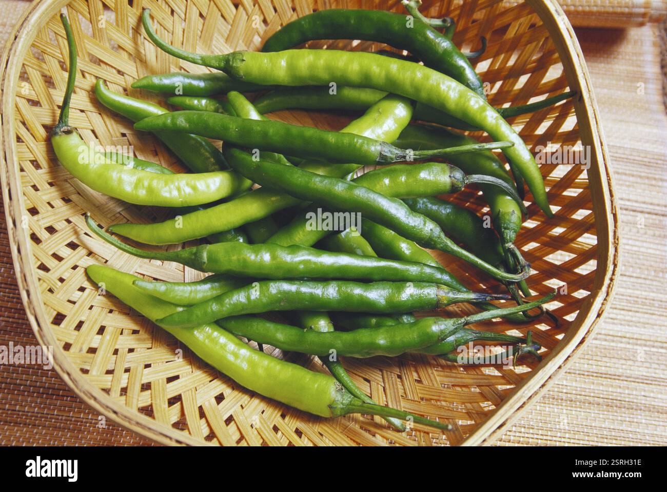 Indian spices, green chillies capsicum frutescens in bucket Stock Photo ...