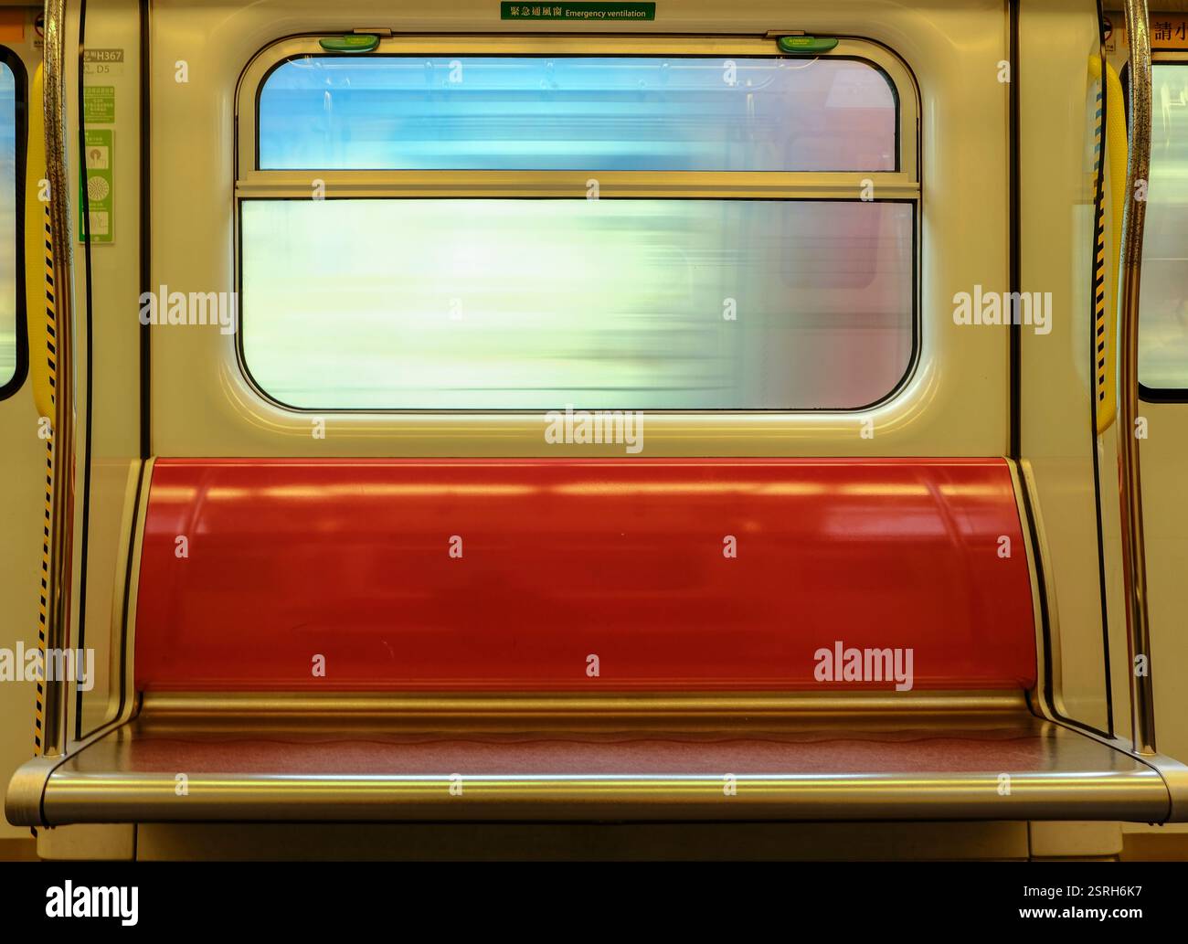 An empty MTR coach in Hong Kong showcases a blurred view through the ...