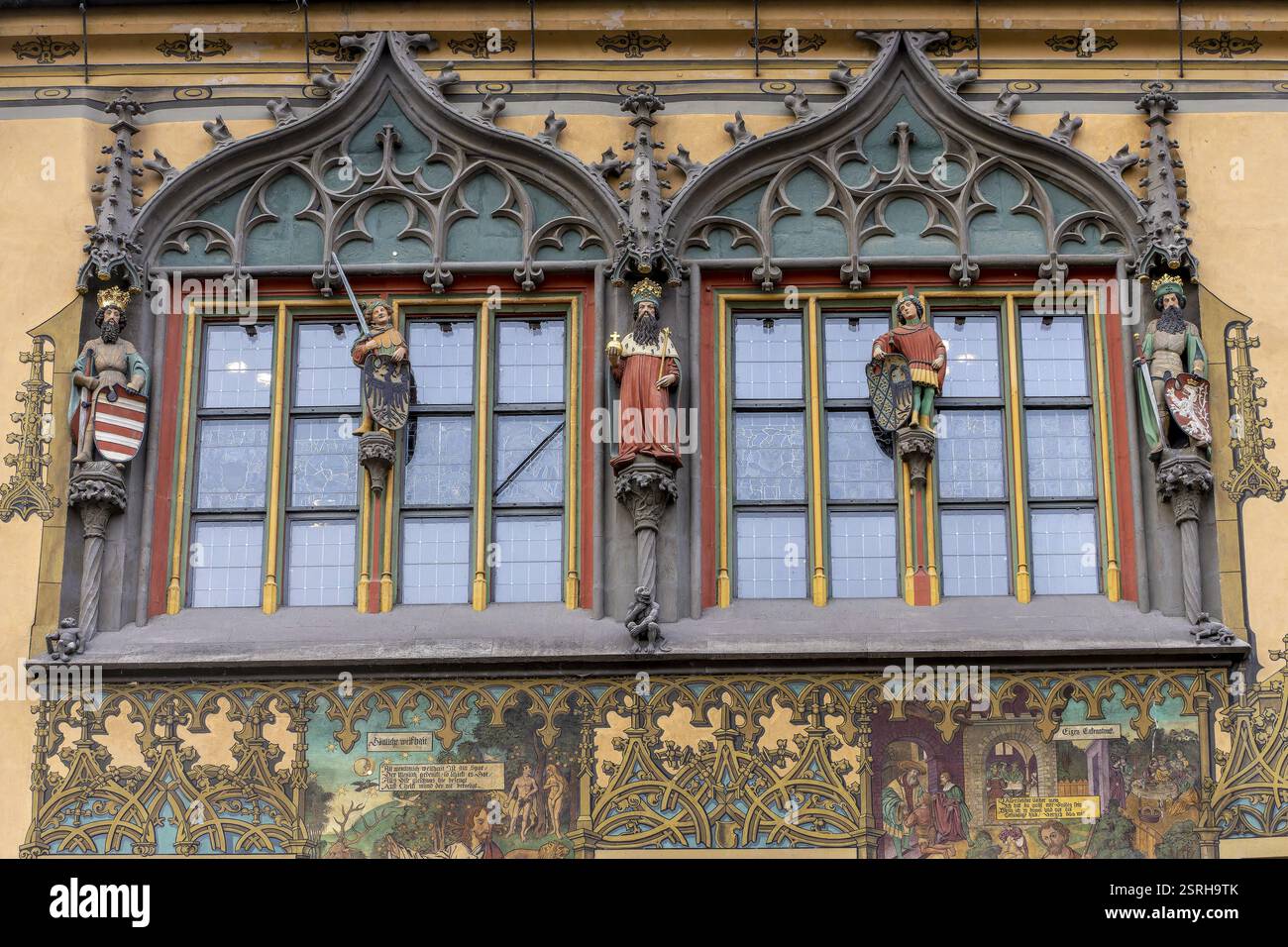 Painted facade and windows with 5 medieval human sculptures on Ulm Town ...