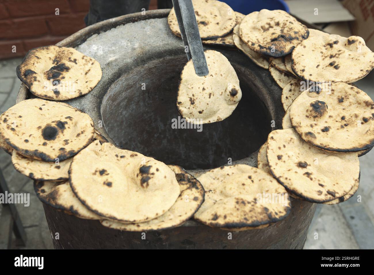 Indian Bread Tandoori Roti baking in Tandoor oven India Stock Photo - Alamy