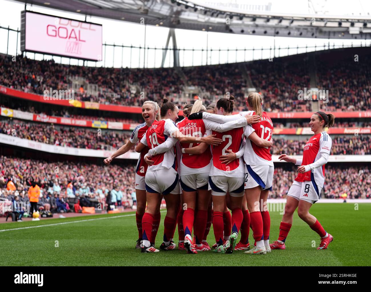 Arsenal players celebrate their side's first goal of the game, an own ...