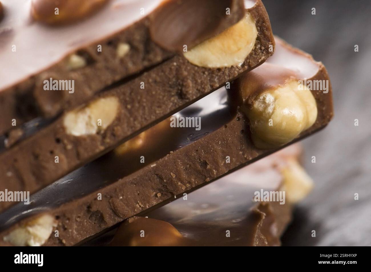 Pile of broken chocolate with nuts Stock Photo - Alamy