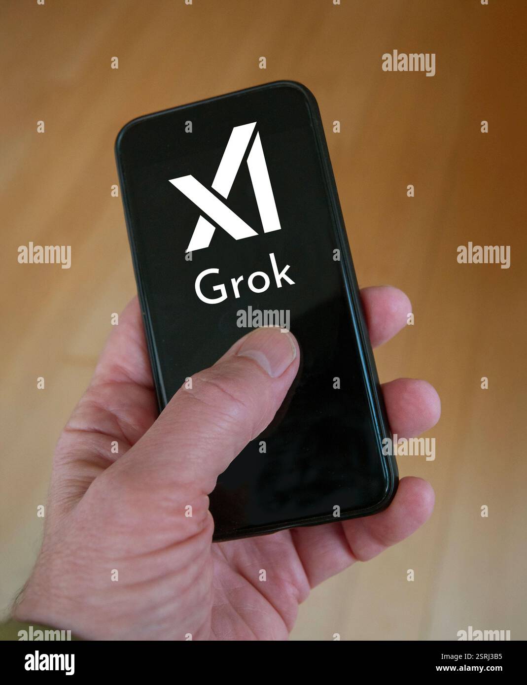 Grok logo from xAI by Elon Musk on smartphone screen held in hand ...